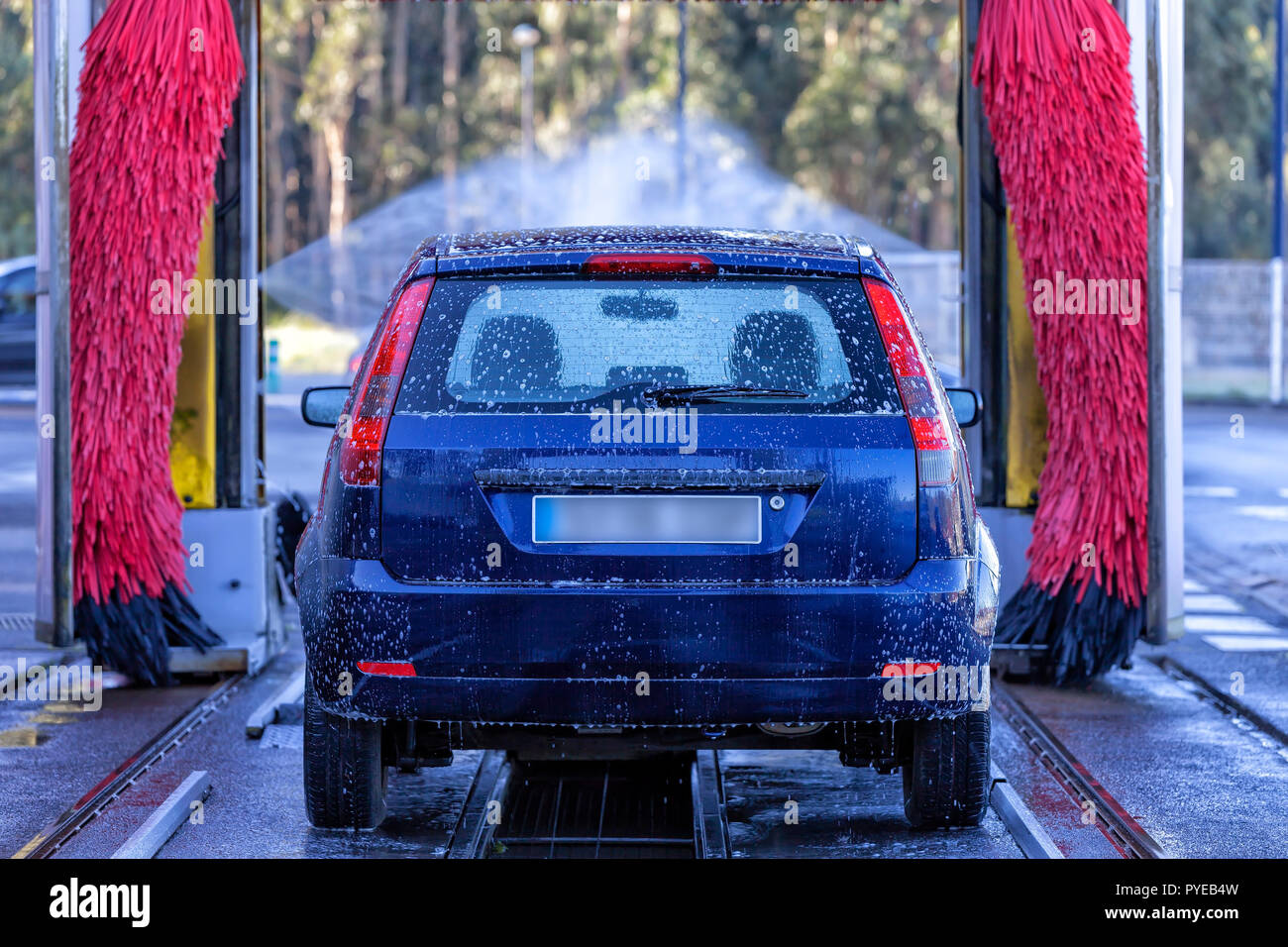 A blue car soaped inside a car washing machine Stock Photo - Alamy