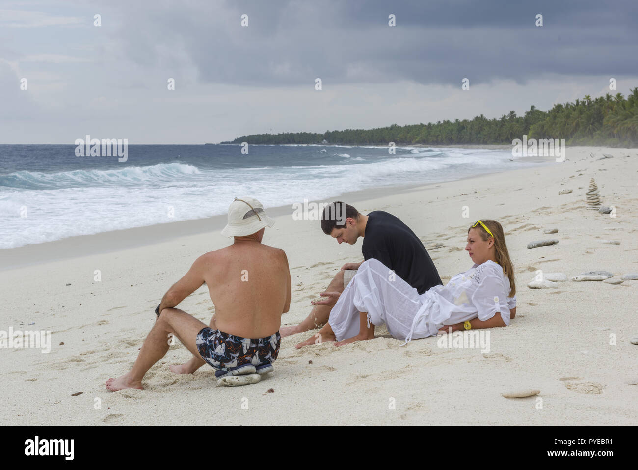 Woman sitting friends on beach hi-res stock photography and images - Alamy