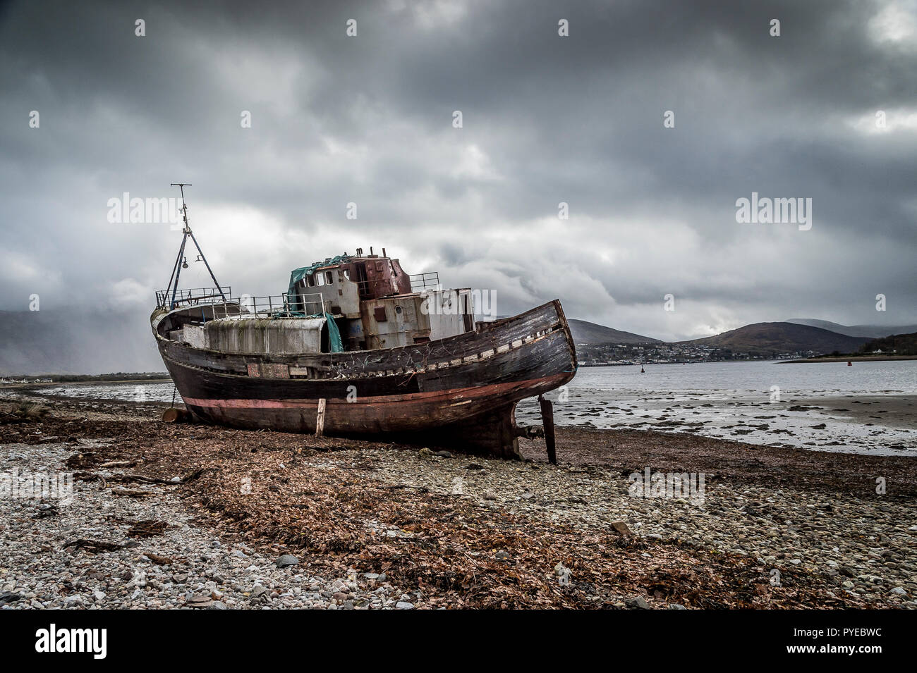Abandoned in shore fishing boat at Corpach on the beach of Loch Linnhe ...