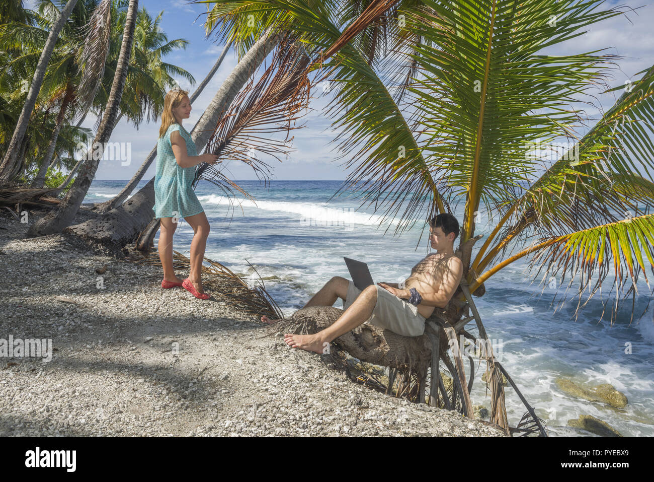 Working on laptop computer on beach hi-res stock photography and images ...