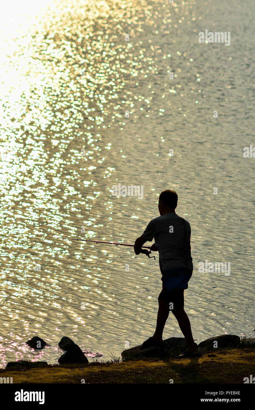 Sunset fishing silhouette Stock Photo - Alamy
