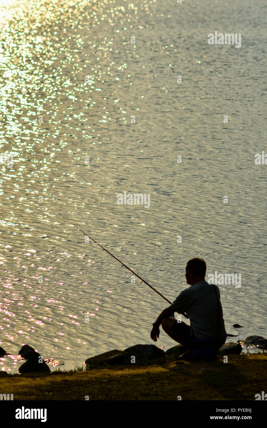 Sunset fishing silhouette Stock Photo - Alamy