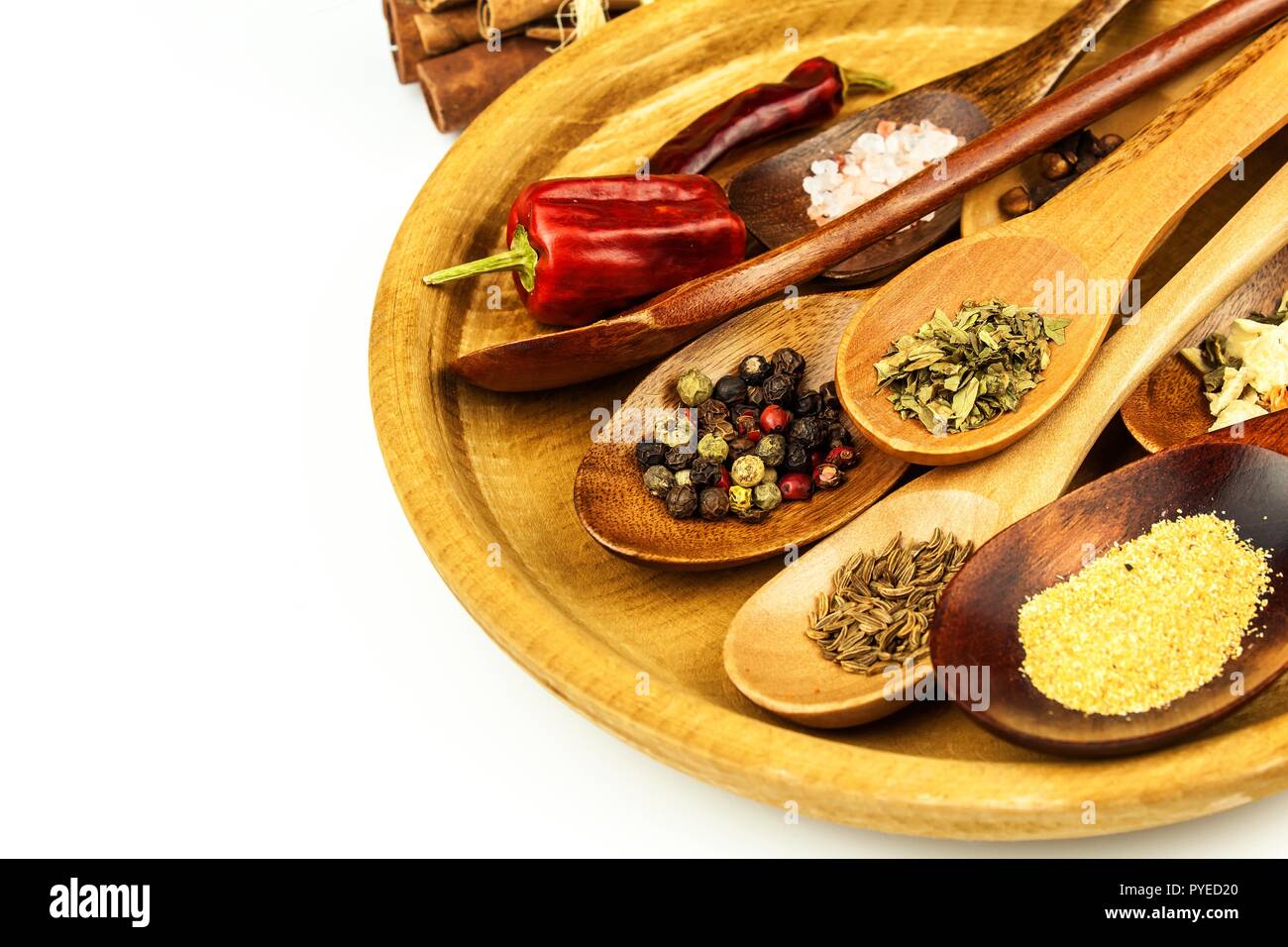 Different spice types on a wooden spoon. Sale of spices. Spices on a ...