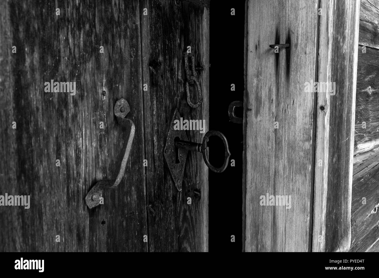 Rustic black iron skeleton key and door lock and handle in an old ...