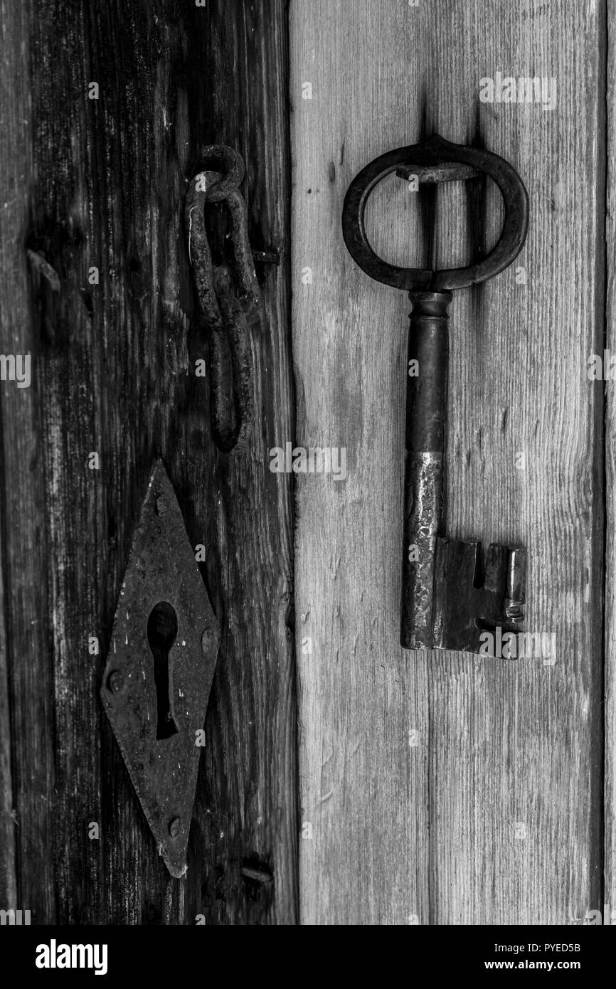 Rustic black iron skeleton key and door lock in an old Swedish farm in ...