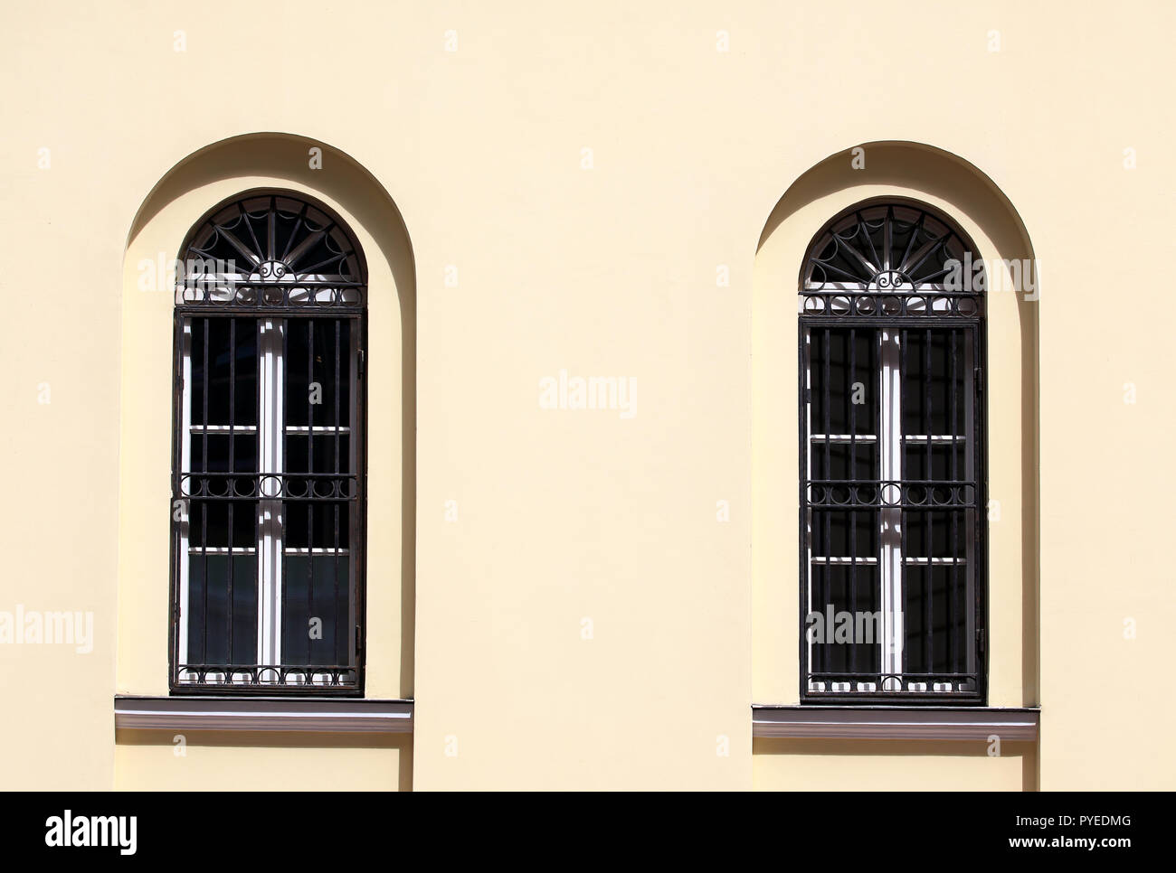 Outside view of two windows on yellow house wall Stock Photo - Alamy