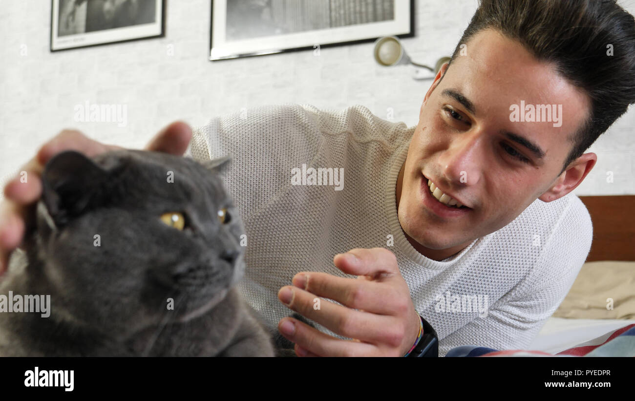Young guy holding a kitten hi-res stock photography and images - Alamy