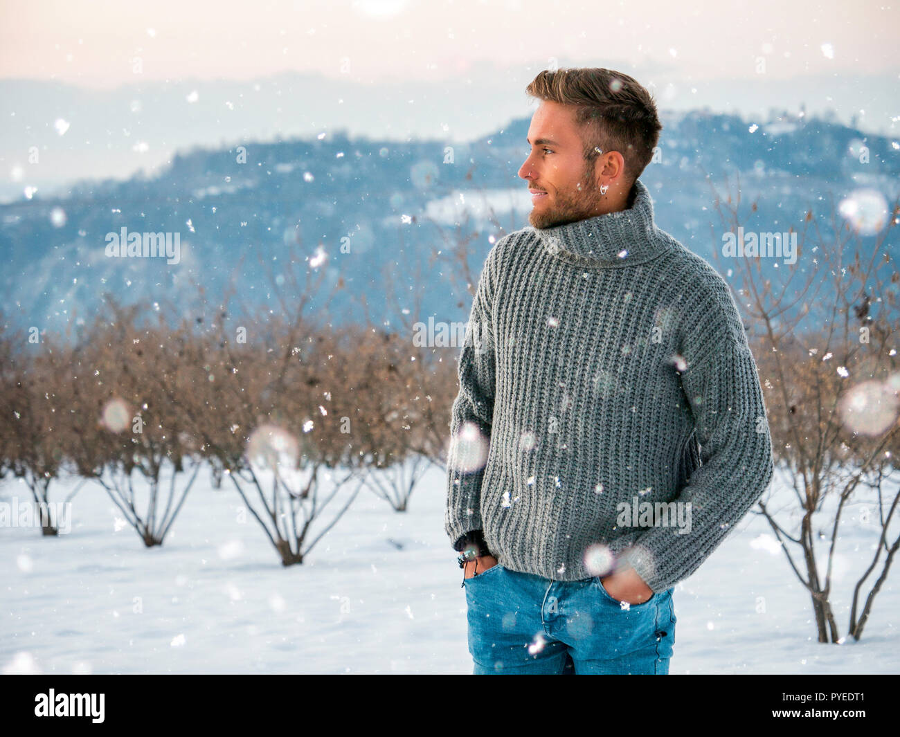 Handsome young man outdoor in winter fashion, wearing black coat and ...