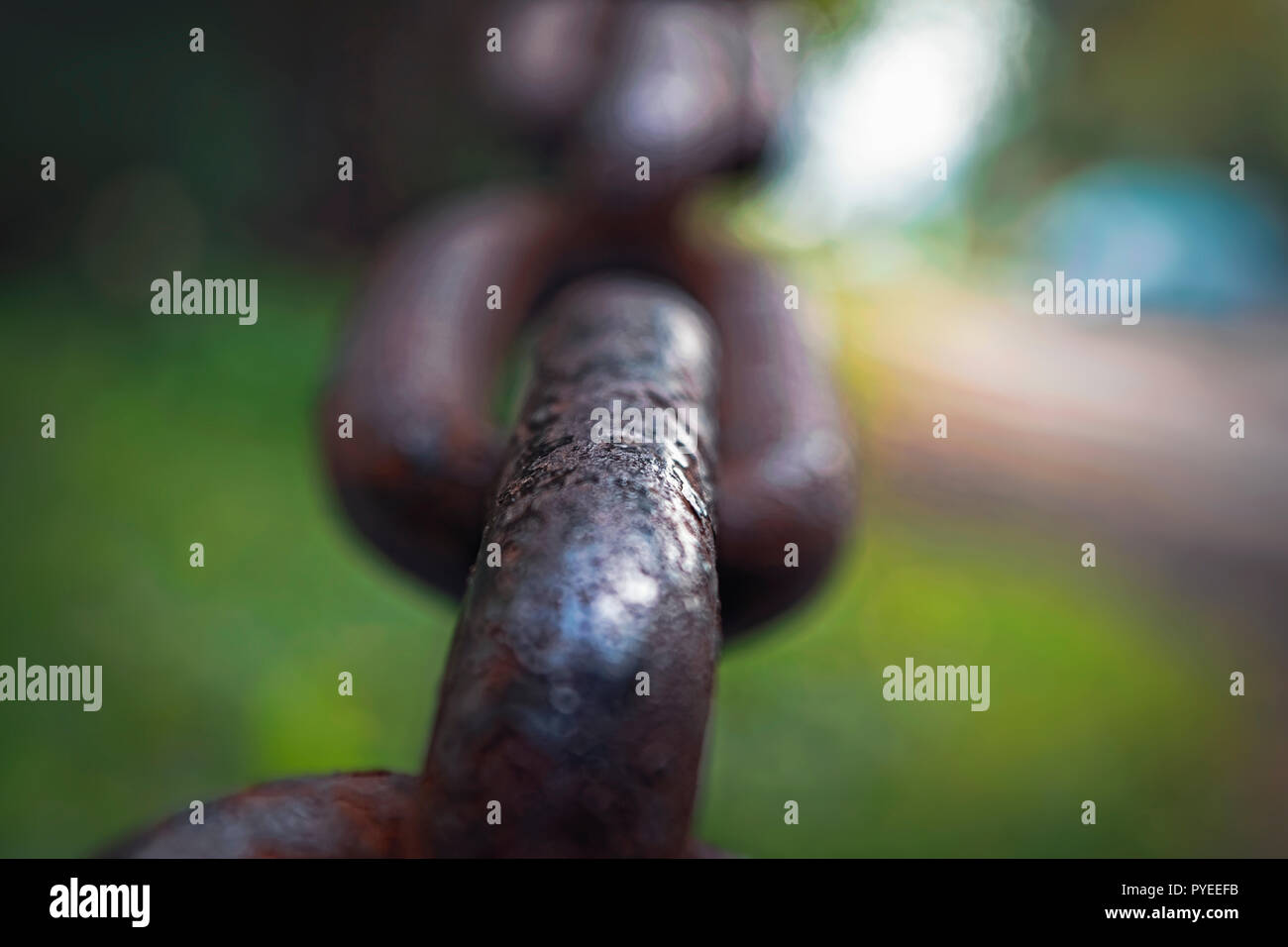 Thick steel chain on blurred background Stock Photo - Alamy