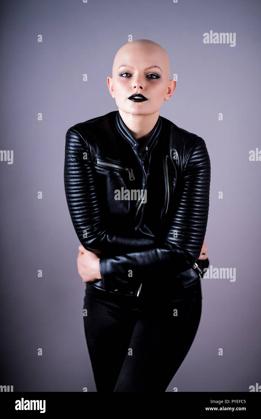 Emotive photo of a beautiful bald woman while standing in the studio ...