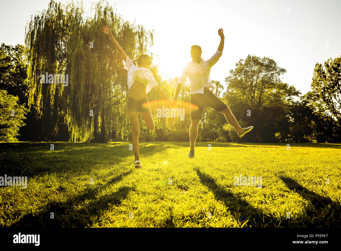 Happy couple jumping joy outside hi-res stock photography and images ...