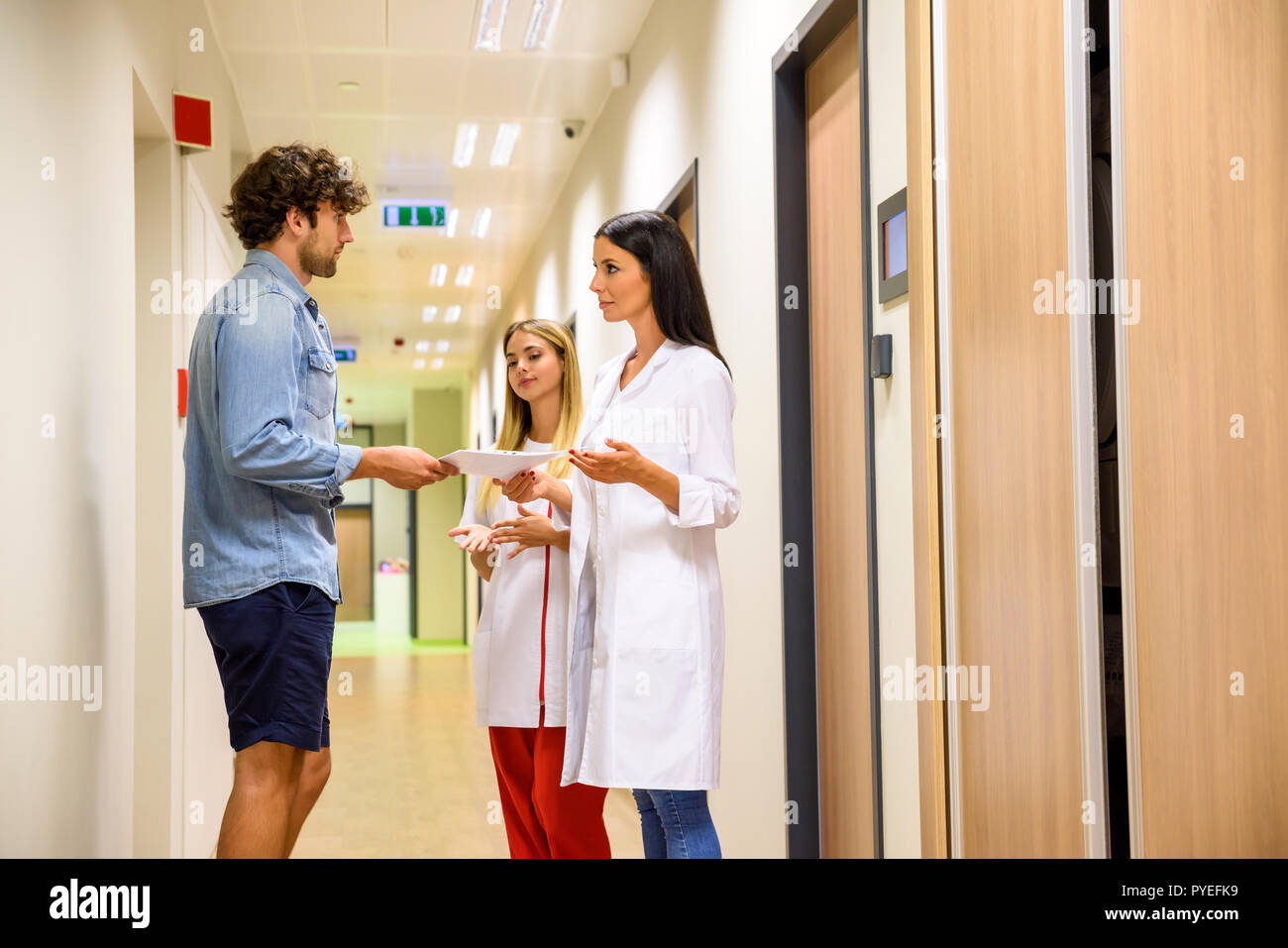 A doctor and a nurse discussing the Diagnosis with the patient or ...