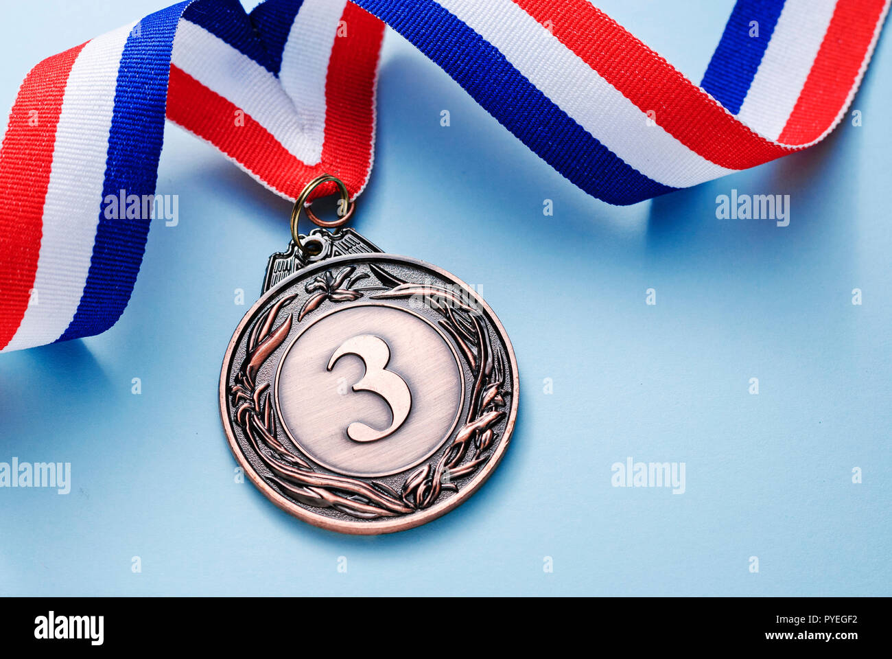 Bronze medal 3 place with a ribbon on a light blue background, the ...