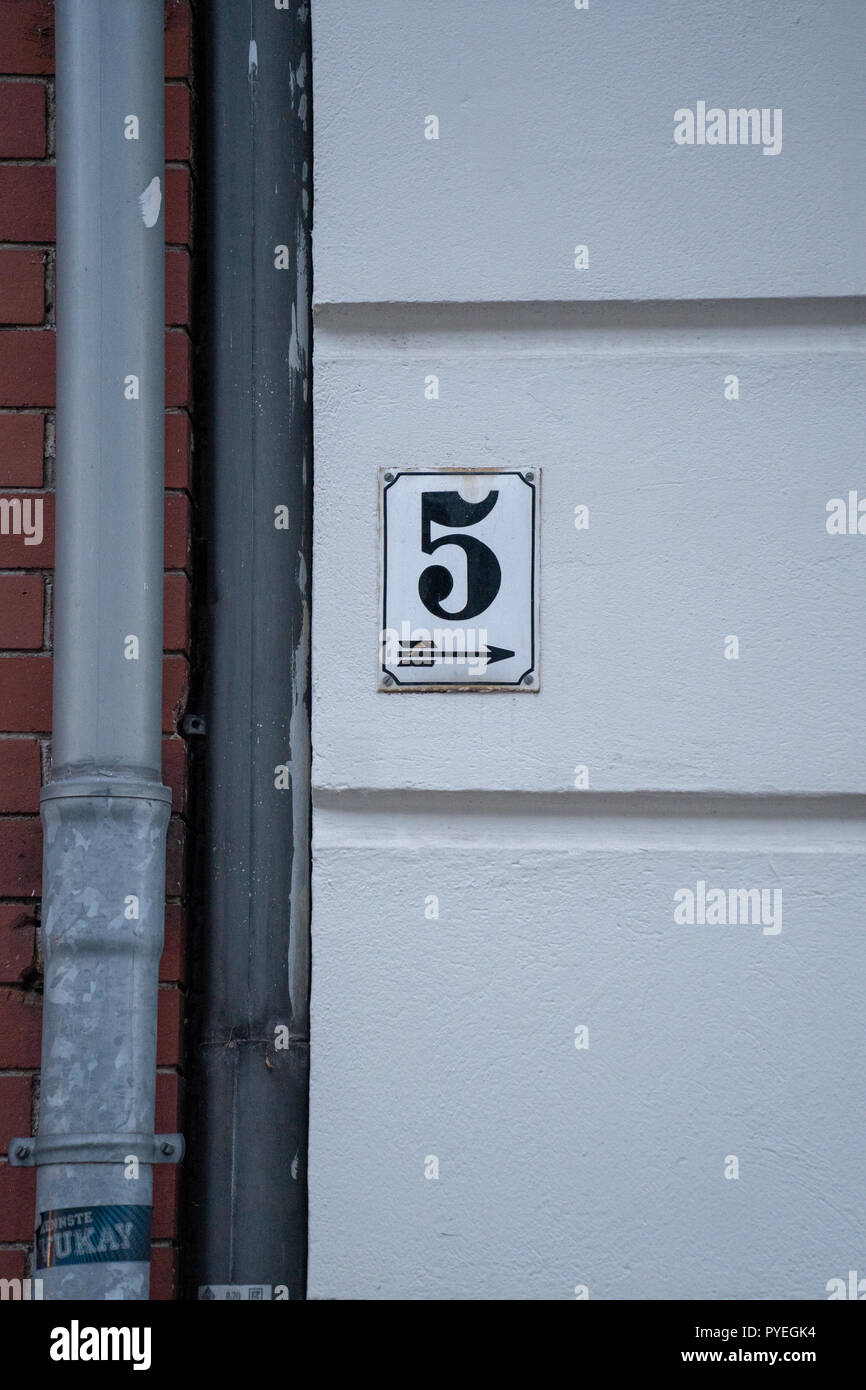 House Number with Digit 5 with an Arrow to the right on a white wall ...