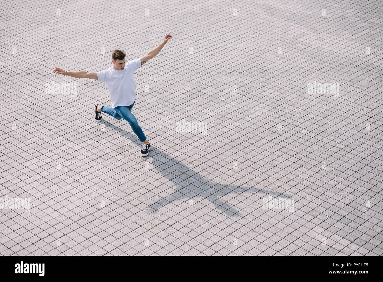 high angle view of handsome young man performing contemporary dance on ...