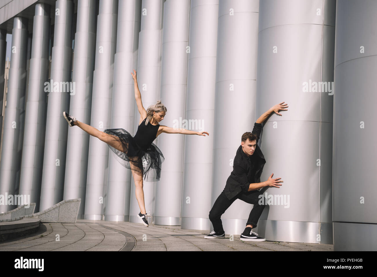 beautiful young dancers in black clothes dancing near columns Stock ...