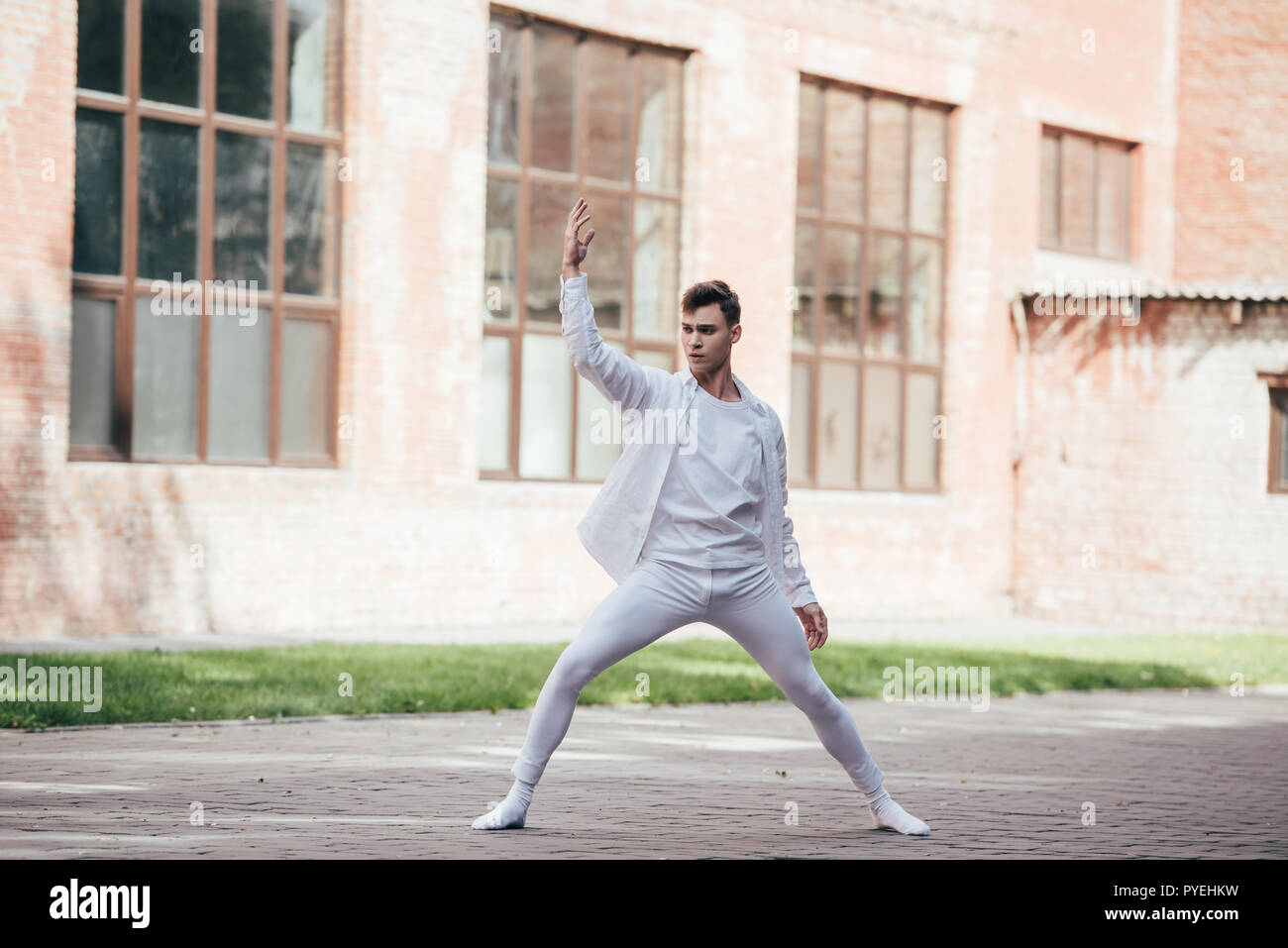 handsome elegant young man dancing on urban city street Stock Photo - Alamy