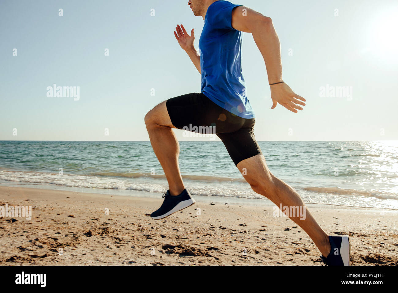 men runner summer run along sandy coast in sun Stock Photo - Alamy