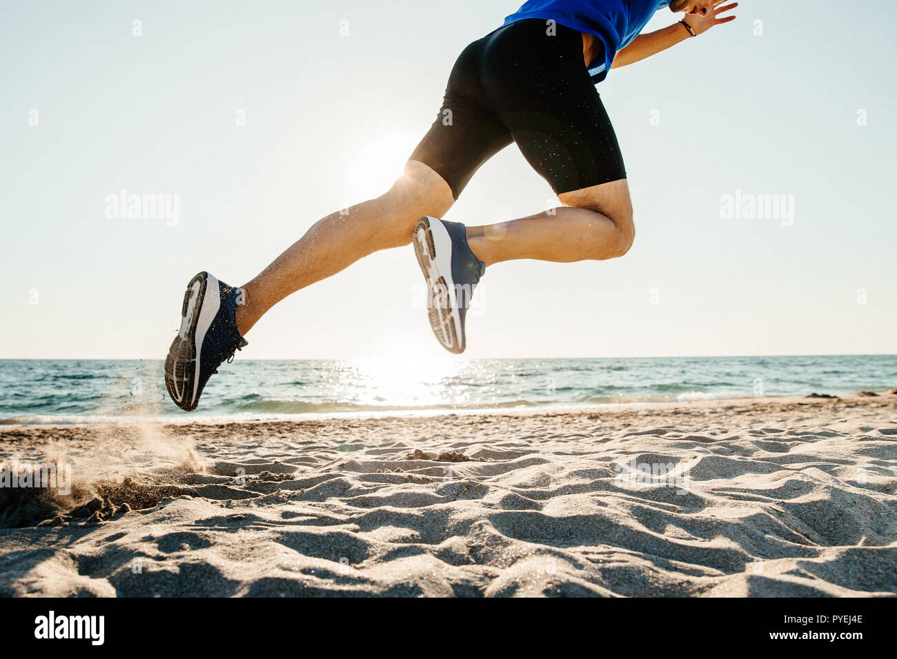 start running on sand athlete runner on beach in sunlight Stock Photo ...