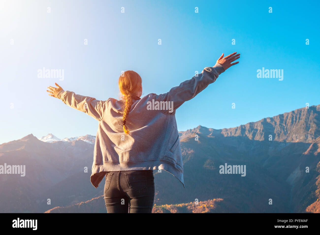 Beautiful girl with raised arms to the mountains of Svaneti, relax ...