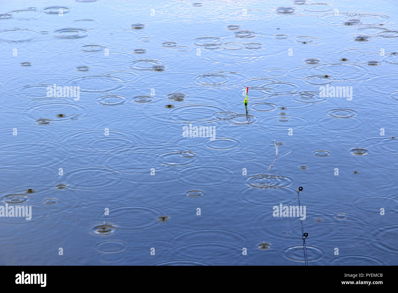 Rain on river during fishing. Fishing float on water while raining ...