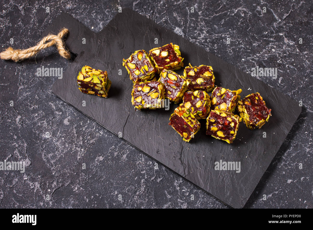 Turkish delight with pistachio nuts on dark stone background Stock ...