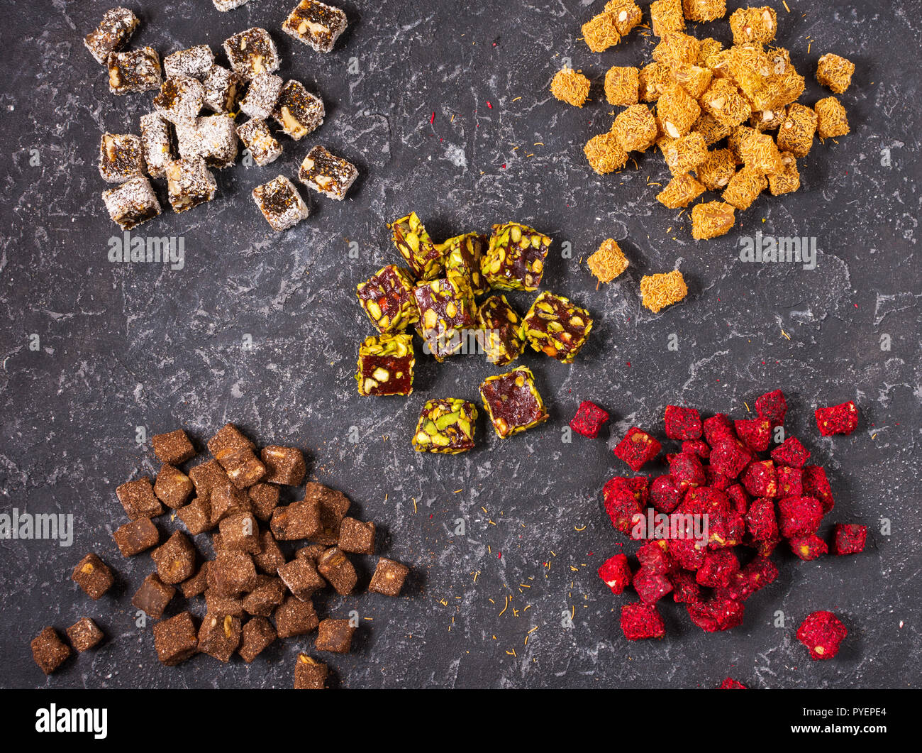 Different types of Turkish delight on dark stone background. Top view ...