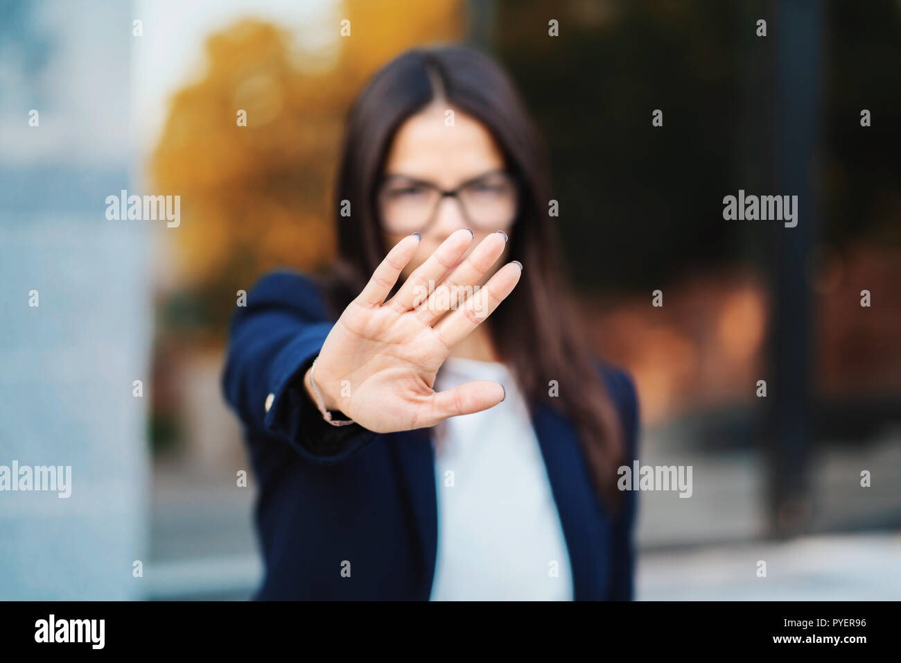 Portrait of young businesswoman disapproval gesture with hand: denial ...