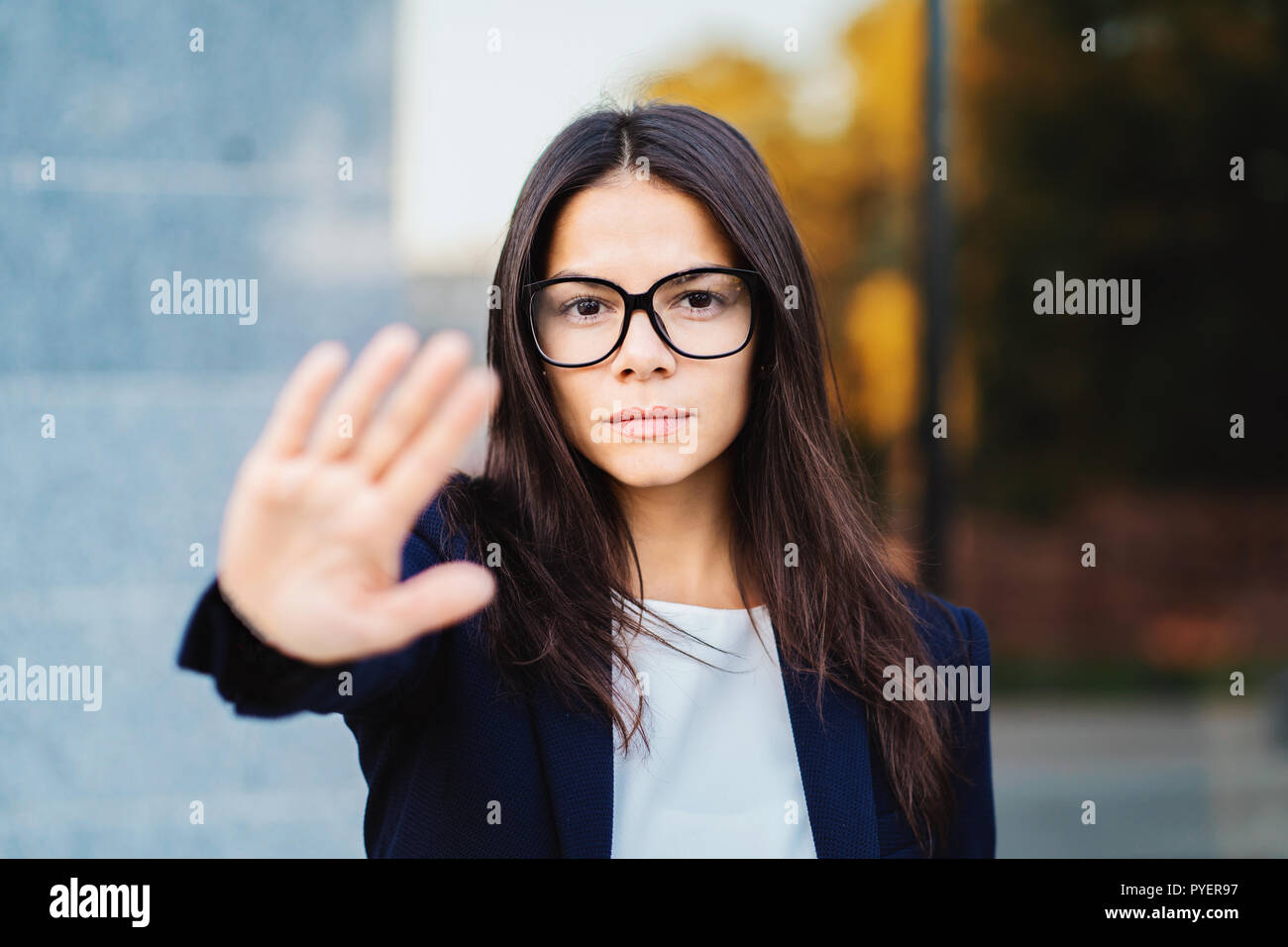 Portrait of young businesswoman disapproval gesture with hand: denial ...