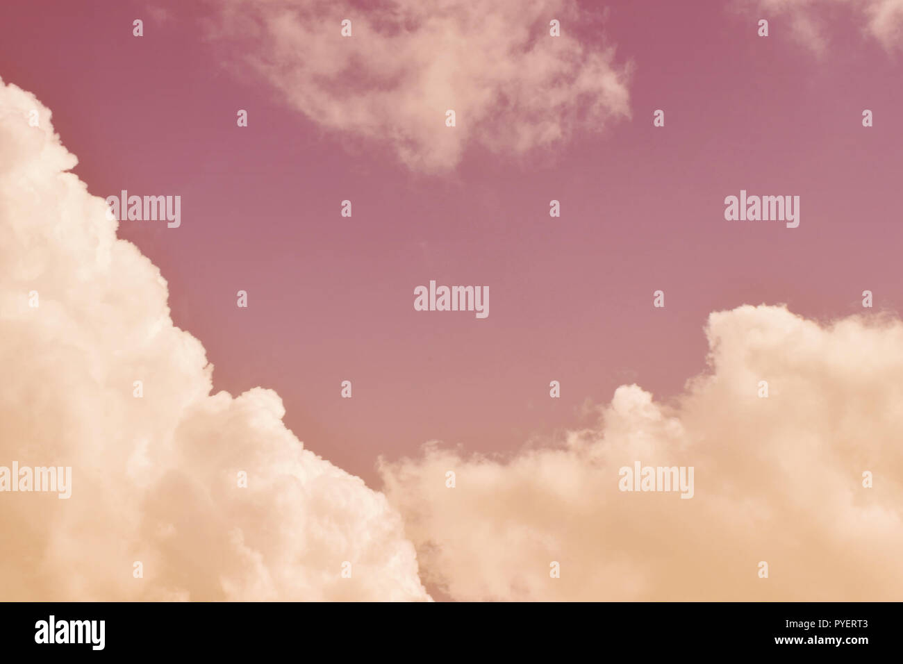 Nature background. Fluffy soft clouds in sky toned Stock Photo - Alamy