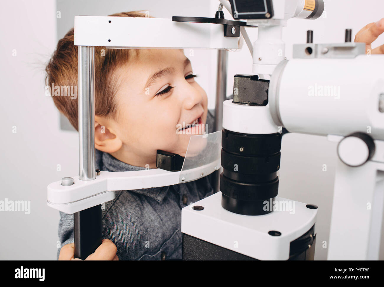 Happyboy receiving eye exam at clinic, eyesight examination children ...
