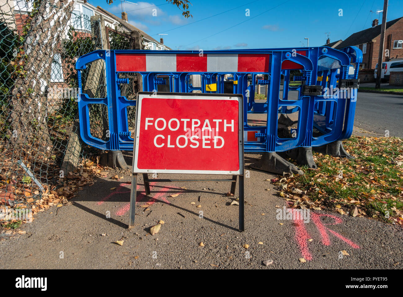 Plastic barriers around holes in the ground where maintenance work is ...