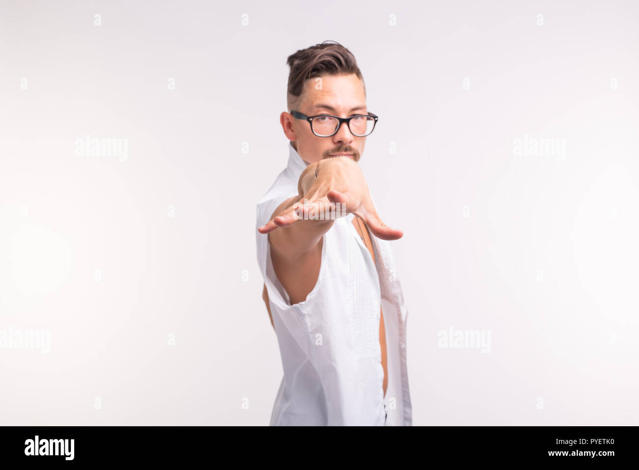 Expression and gesture concept - Young man in white shirt with his hand ...