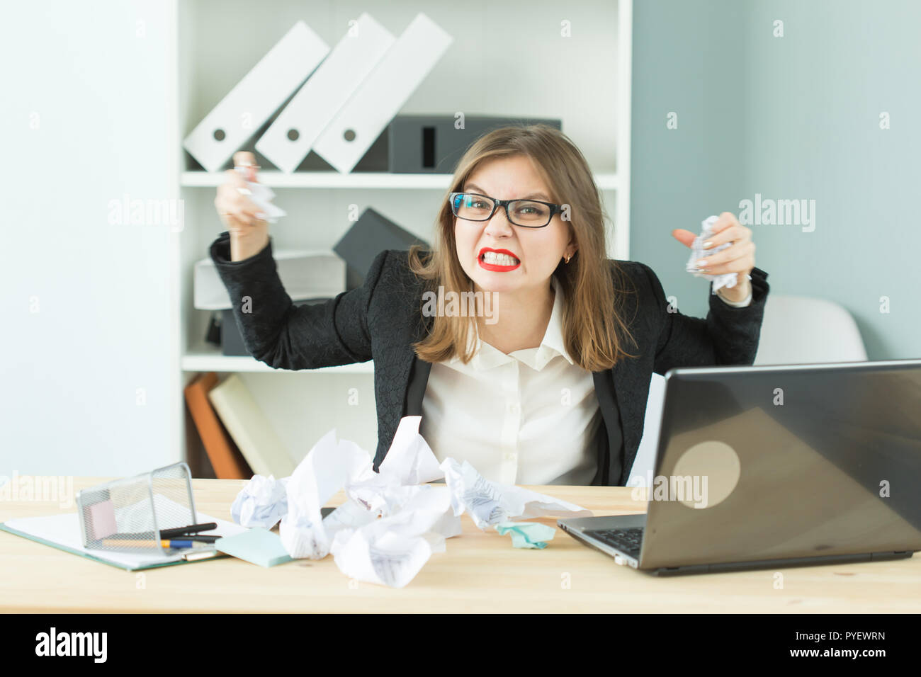People, business and emotions concept - Angry woman sitting at desk in ...