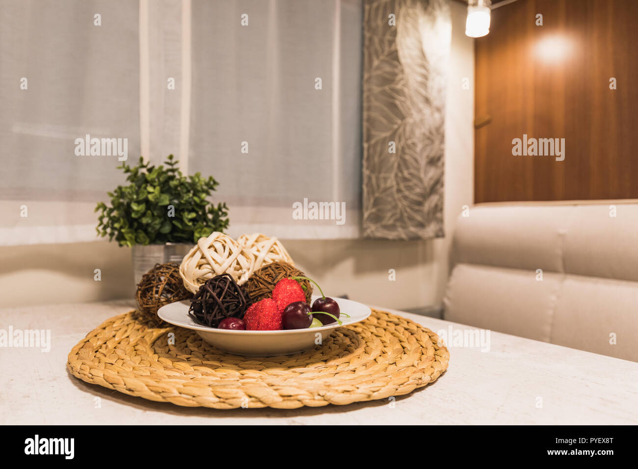 decorative colorful fruits and a flower on a table inside a caravan ...