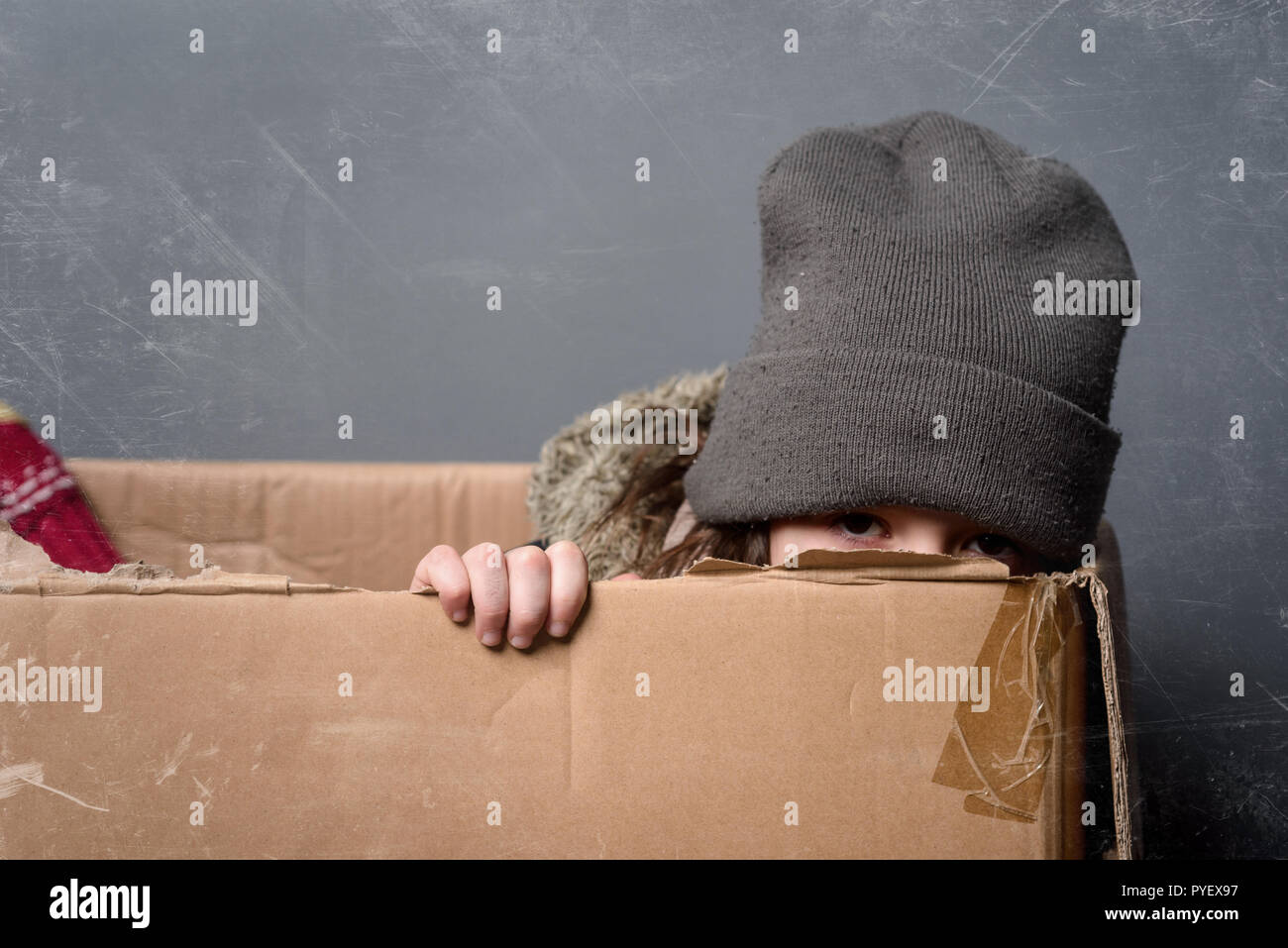 Girl hiding in paper box Stock Photo - Alamy