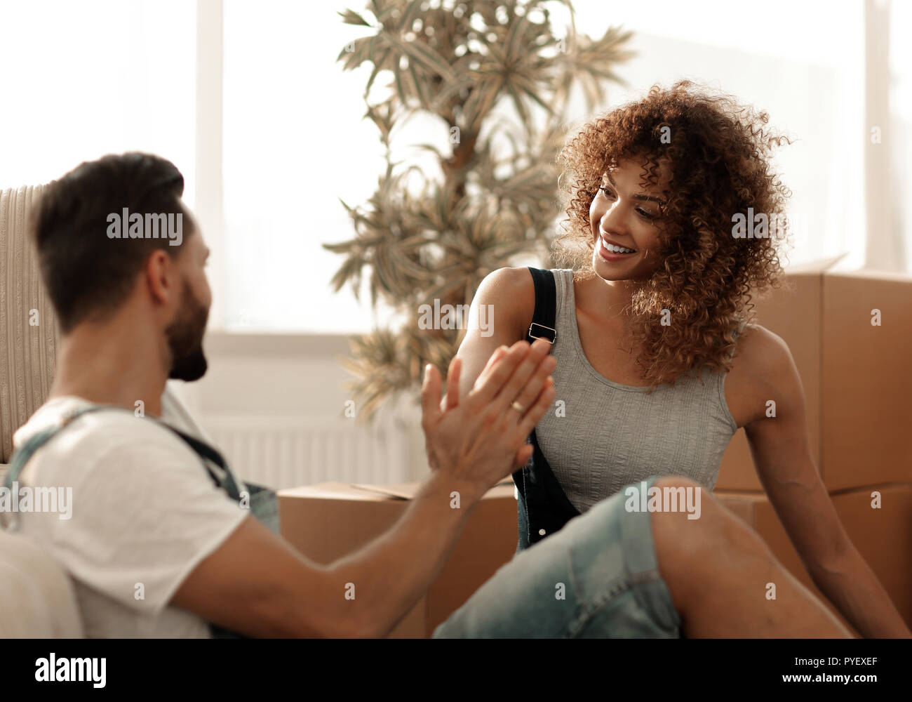 young couple giving each other five with a new home Stock Photo - Alamy