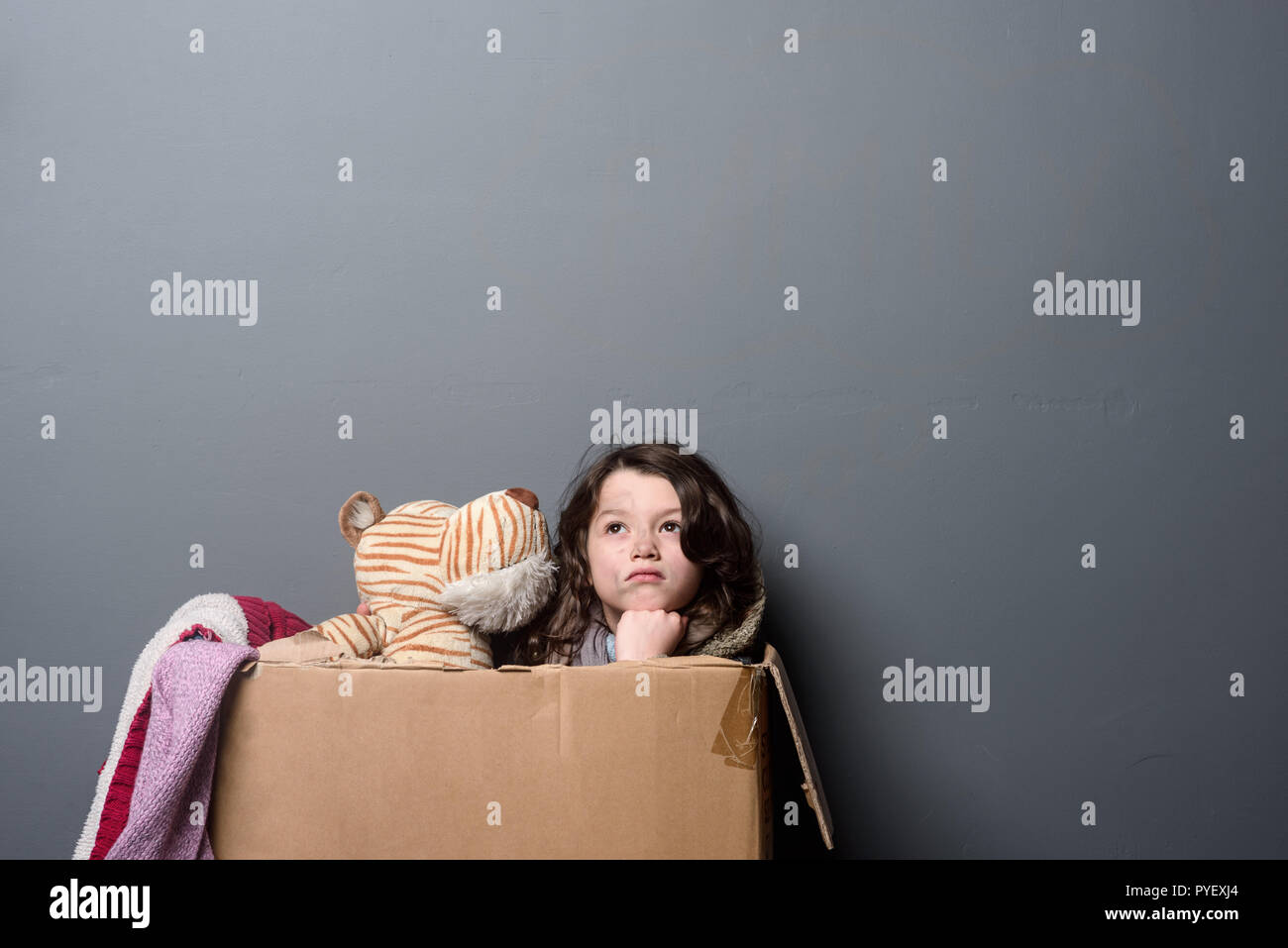 Sad kid thinking Stock Photo - Alamy