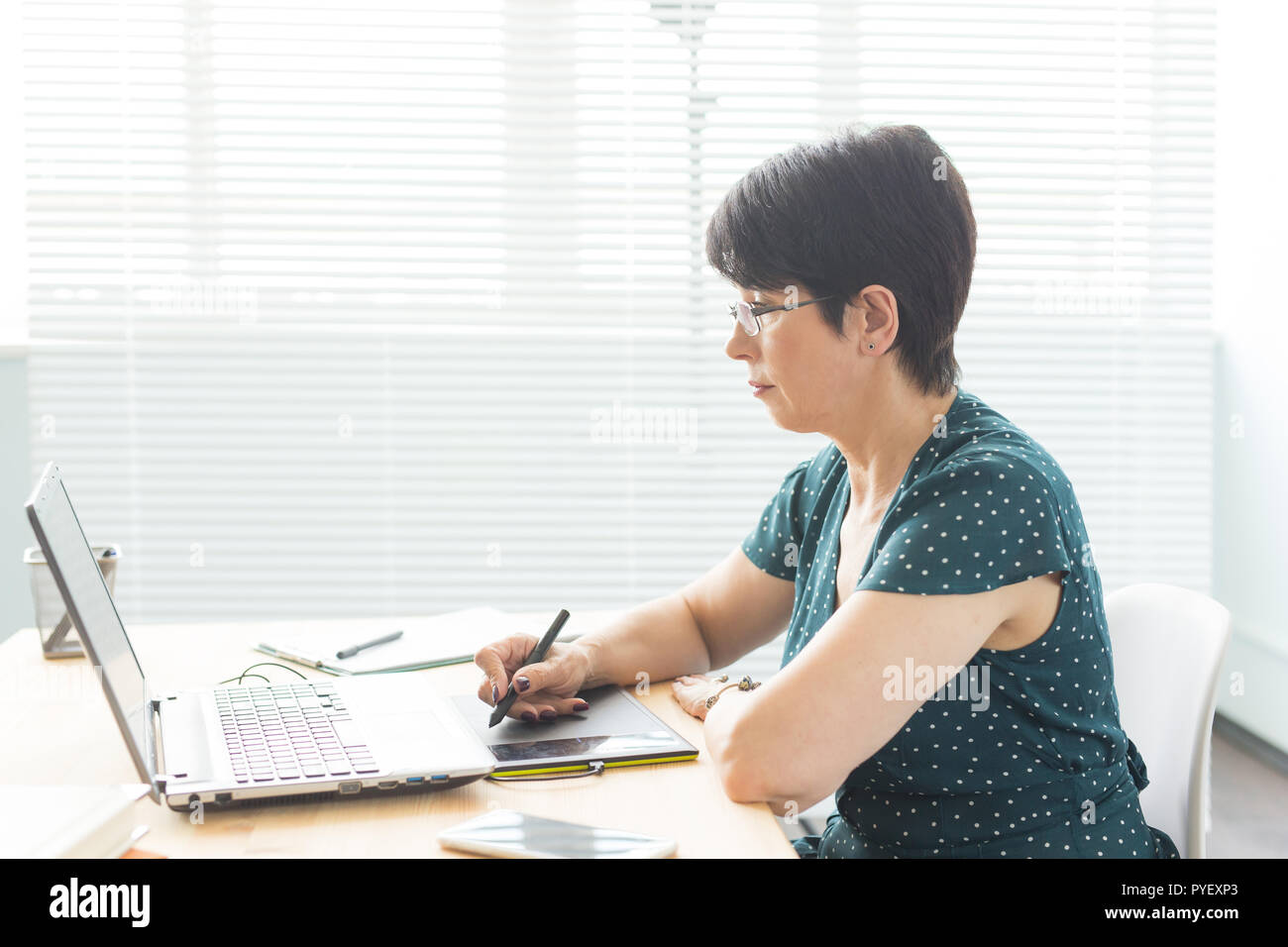 People and graphic designer concept - Middle age woman concentrated ...