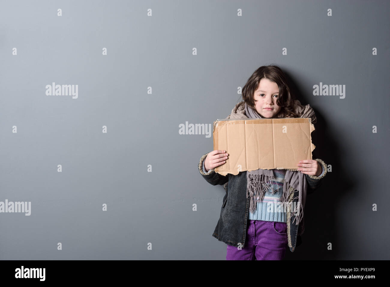 Girl holding piece of paper Stock Photo - Alamy