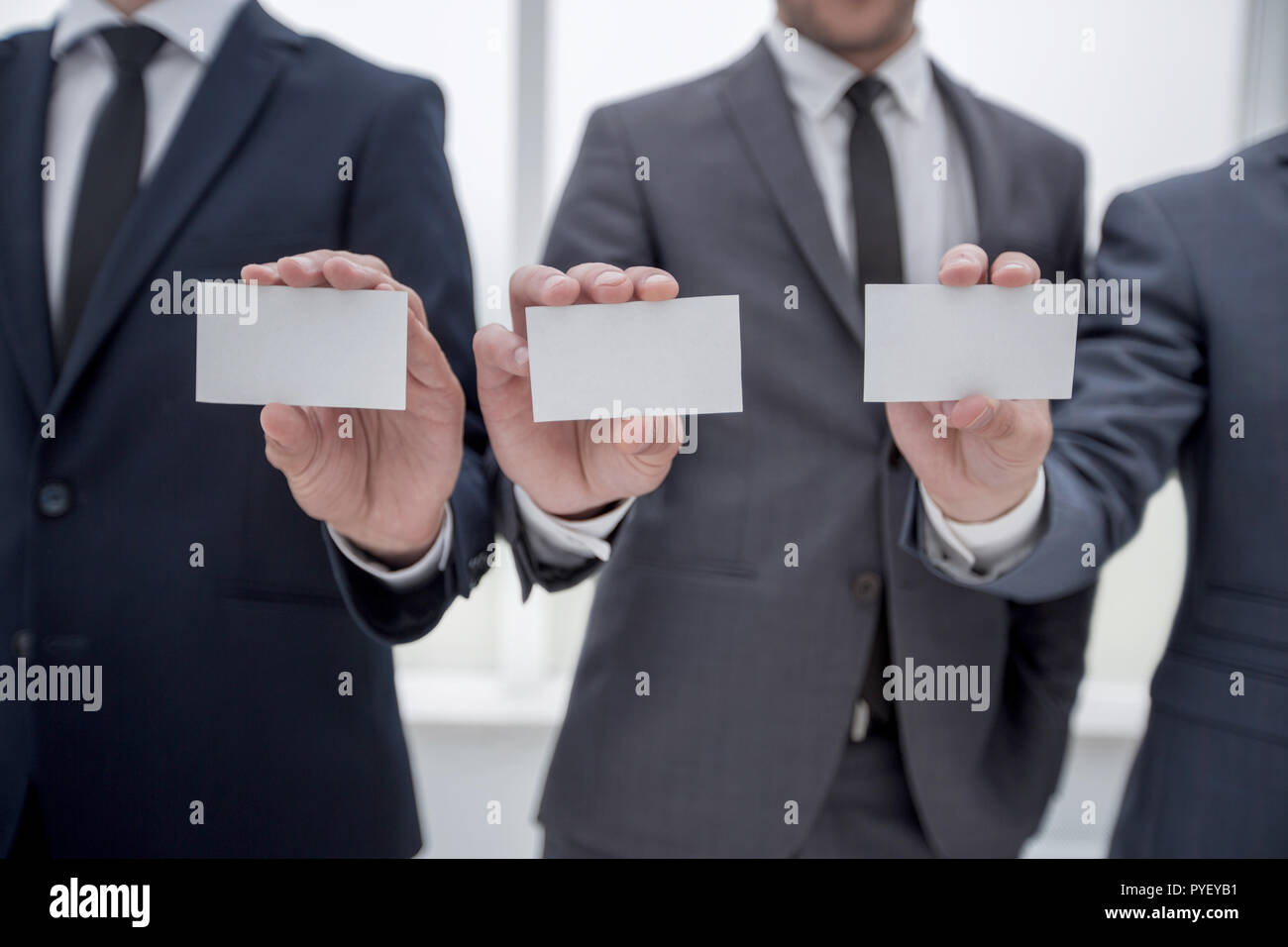 three business partners showing their business card form Stock Photo ...