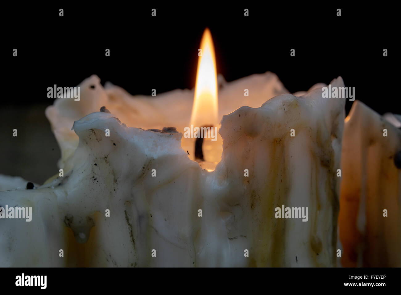 Old candles with dirty wax on a wooden table. Burning dirty ...
