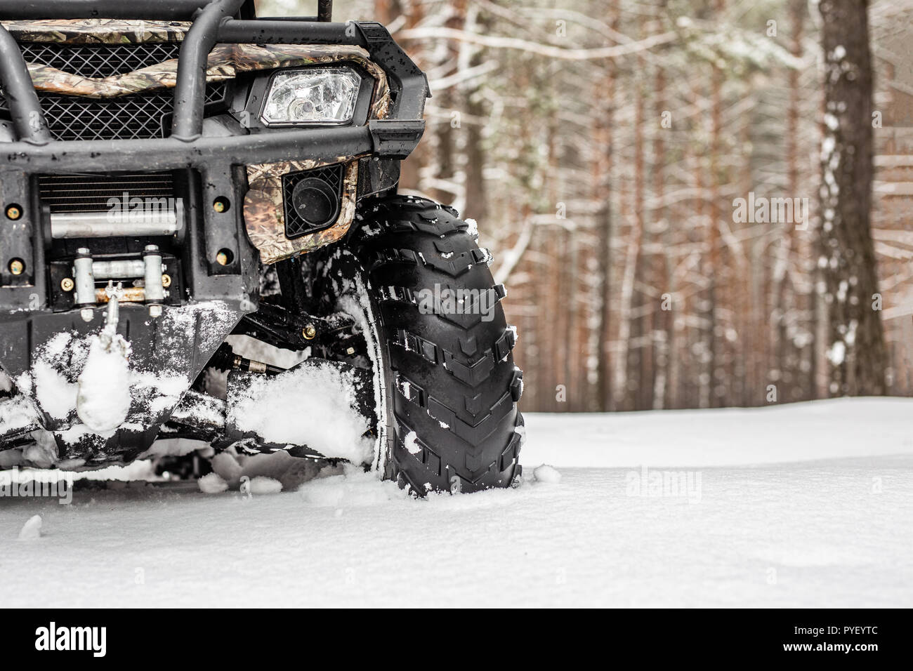 Close-up ATV 4wd quad bike in forest at winter. 4wd all-terreain ...
