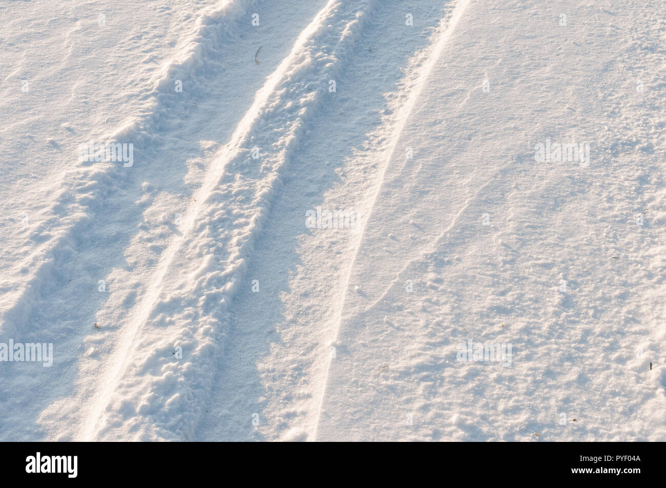 Car tire tracks in fresh snow Stock Photo - Alamy