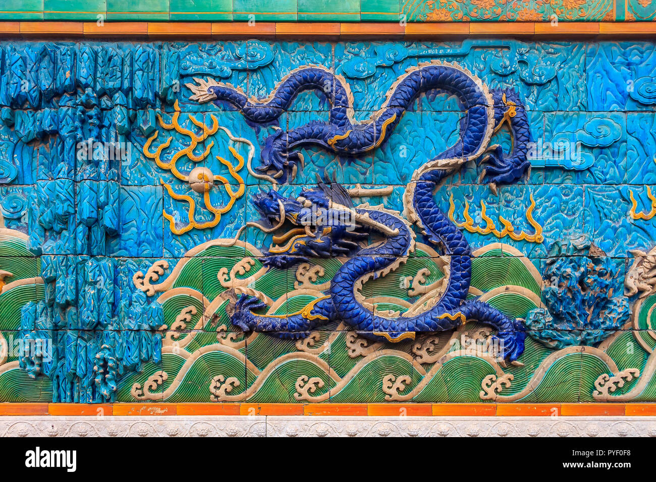 Detail of the Nine Dragon Wall of marble carving of dragons playing ...