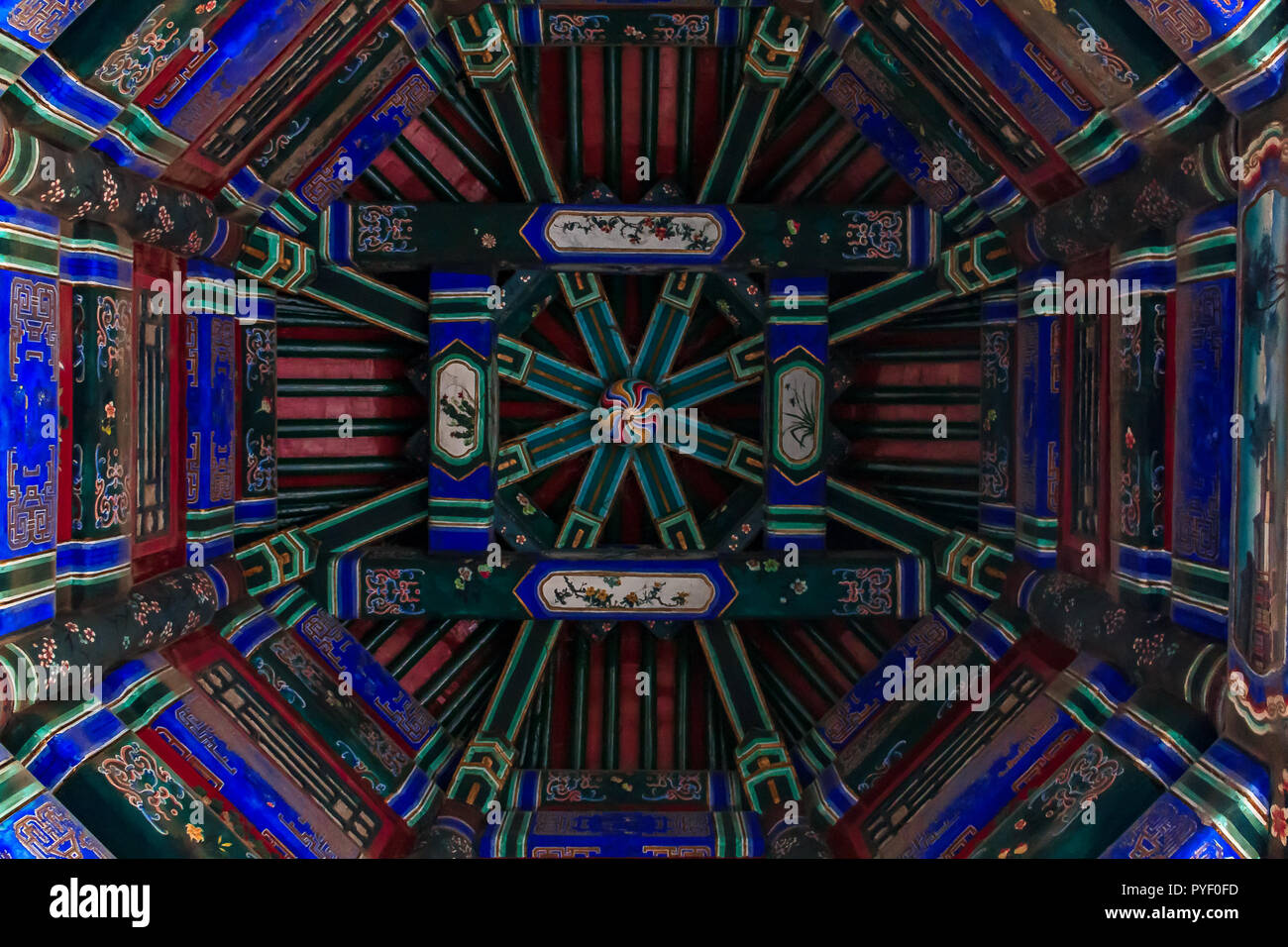 Ornate carved and painted beam and rafters with traditional Chinese ...