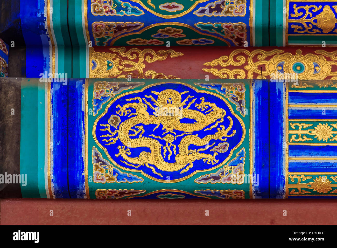 Ornate carved and painted beam and rafters with traditional Chinese ...