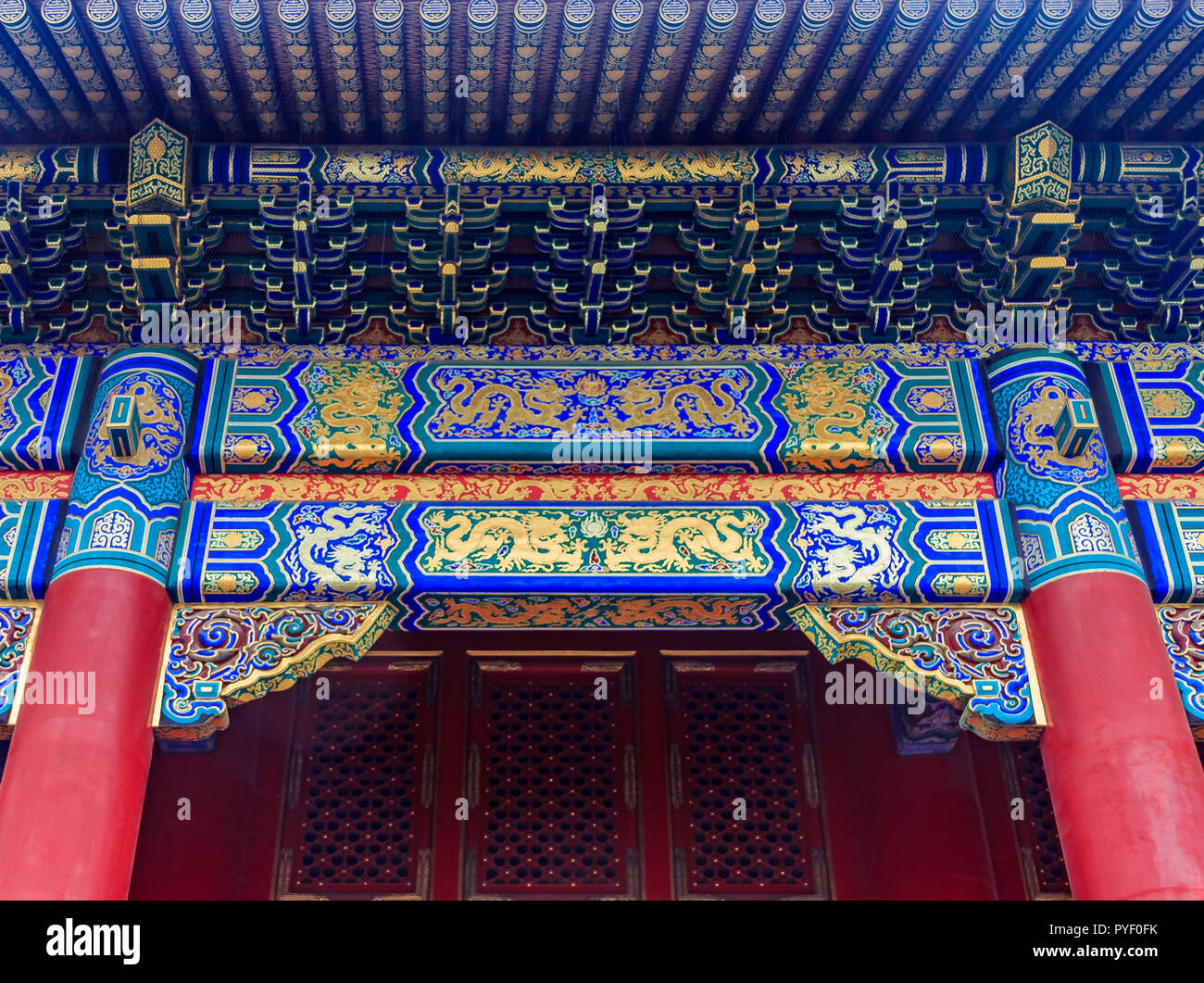 Ornate carved and painted beam and rafters with traditional Chinese ...
