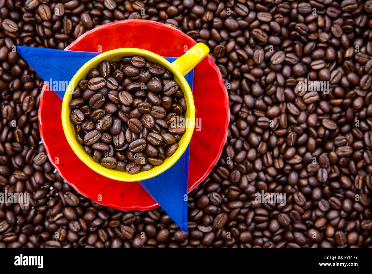 Cup filled with Colombian coffee beans and the colors of the Colombian ...
