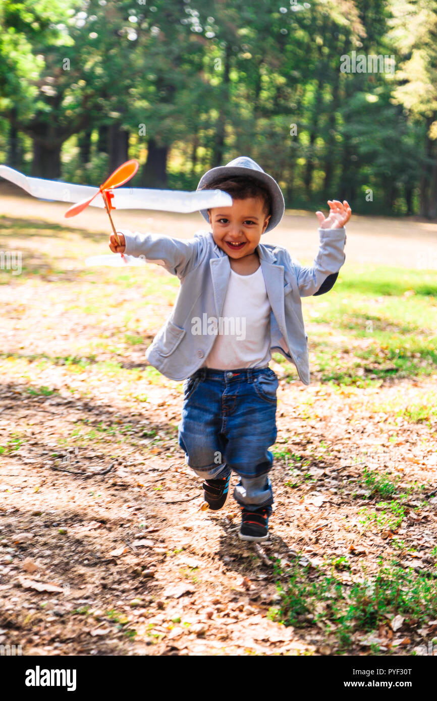 Happy kid playing with toy airplane outdoor Stock Photo - Alamy